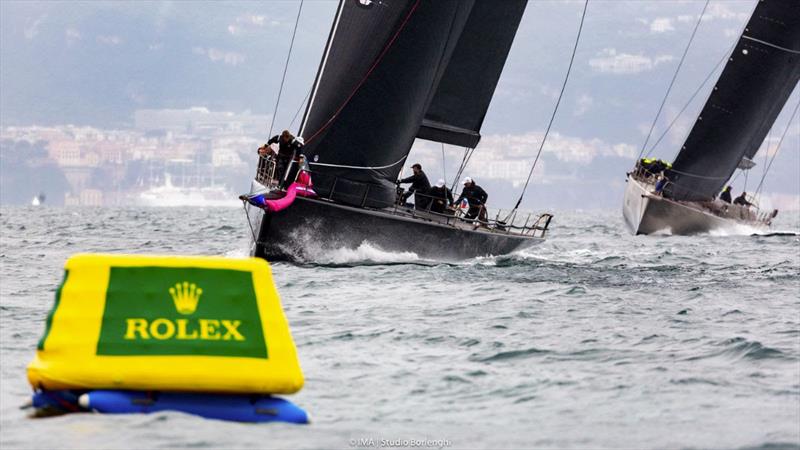Preparing to hoist their characteristic fuchsia-coloured spinnaker on Sir Peter Ogden's Maxi 77 ...
