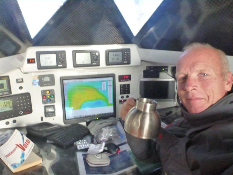 Mike Golding enjoys a tea at the nav station on Gamesa during the ...
