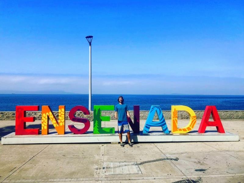Lance in-front of the famous Ensenada sign